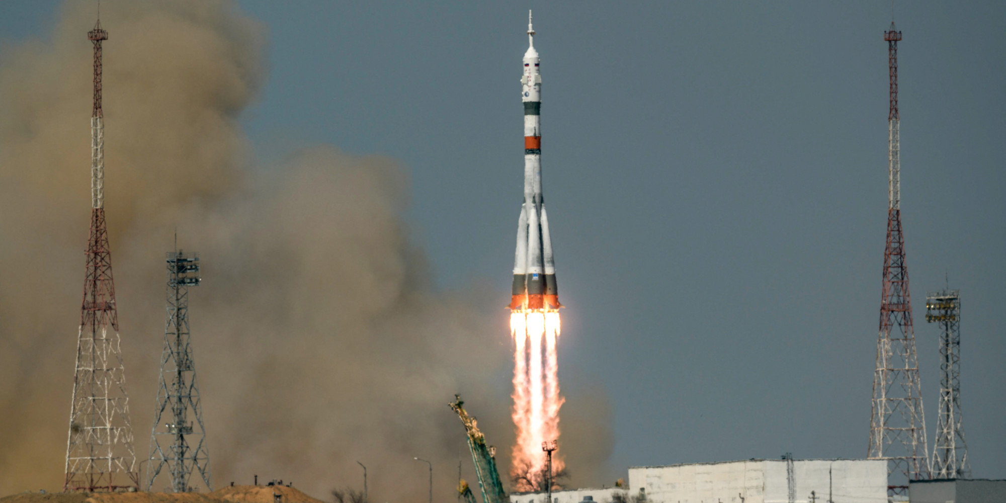 A Soyuz rocket bearing the image of Gagarin takes off with three men on ...